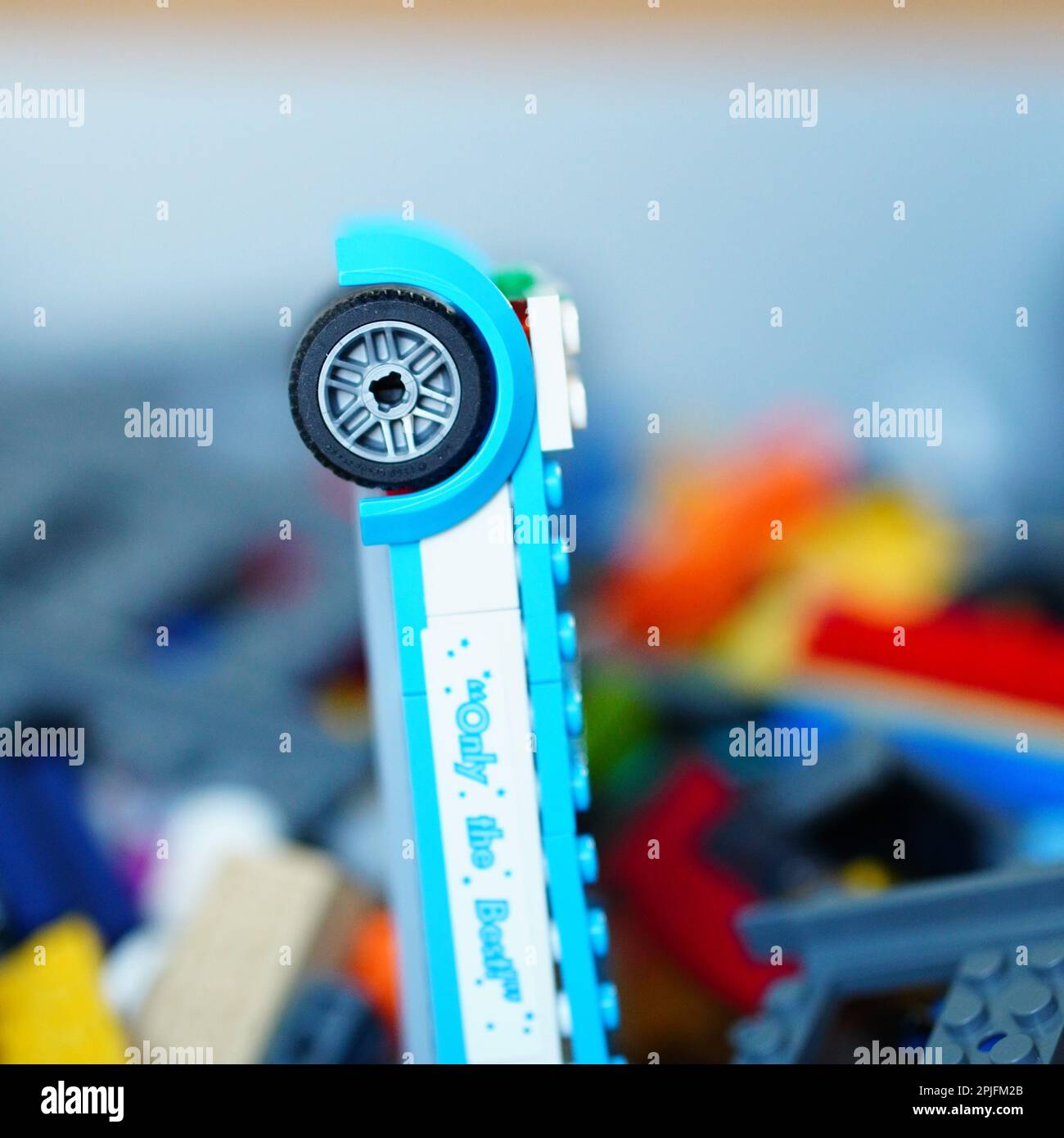 A detailed image of a blue Lego piece with movable wheels attached to ...