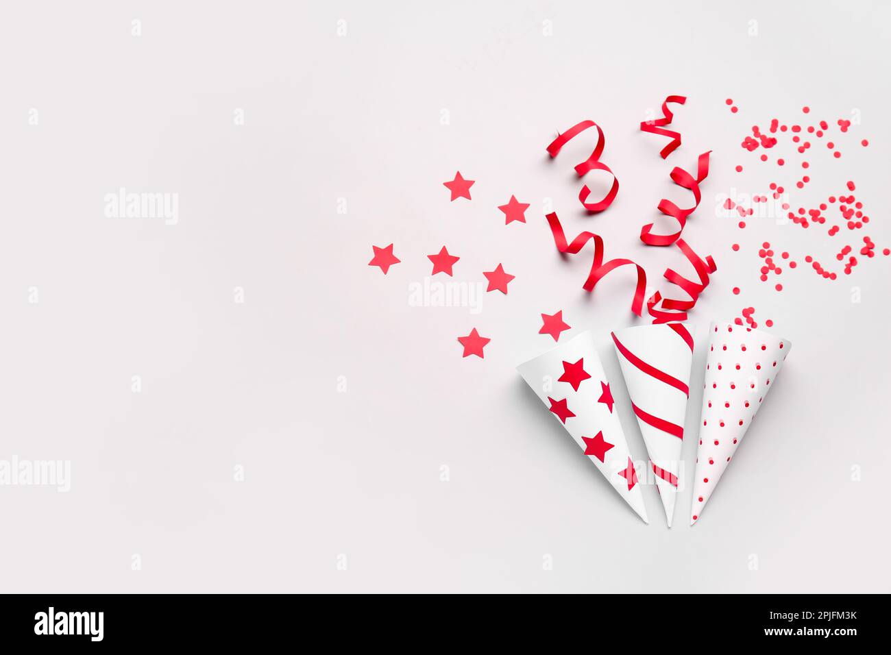 Party cones with serpentine, stars and confetti on light background ...
