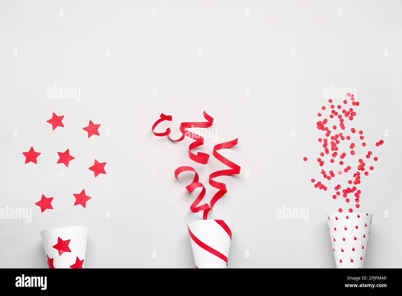 Party cones with serpentine, stars and confetti on light background ...