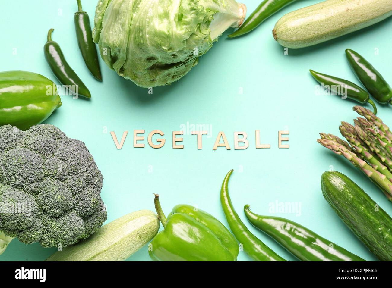 Word VEGETABLE and frame made of different fresh vegetables on blue ...