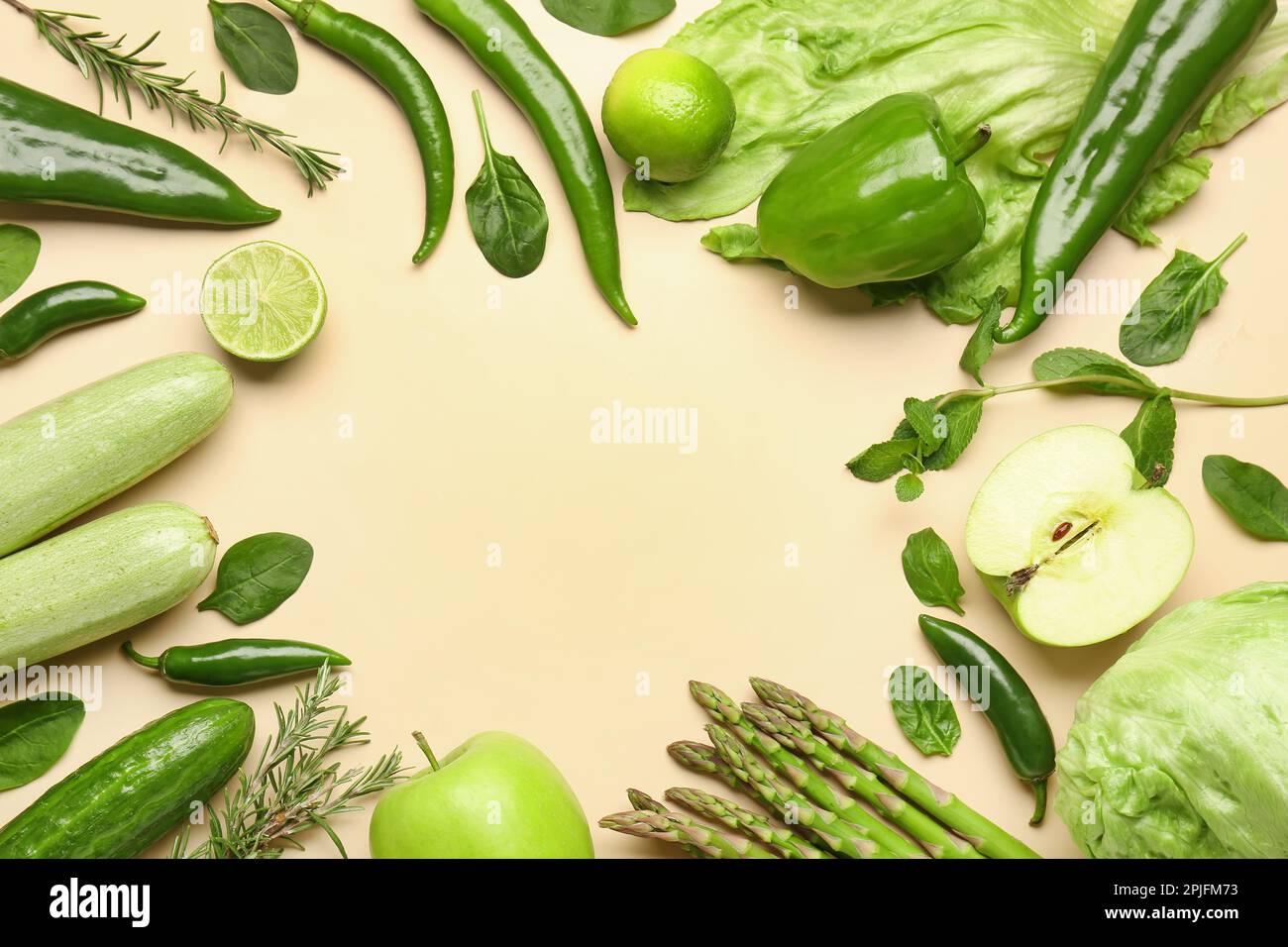 Frame made of different fresh vegetables and fruits on beige background ...