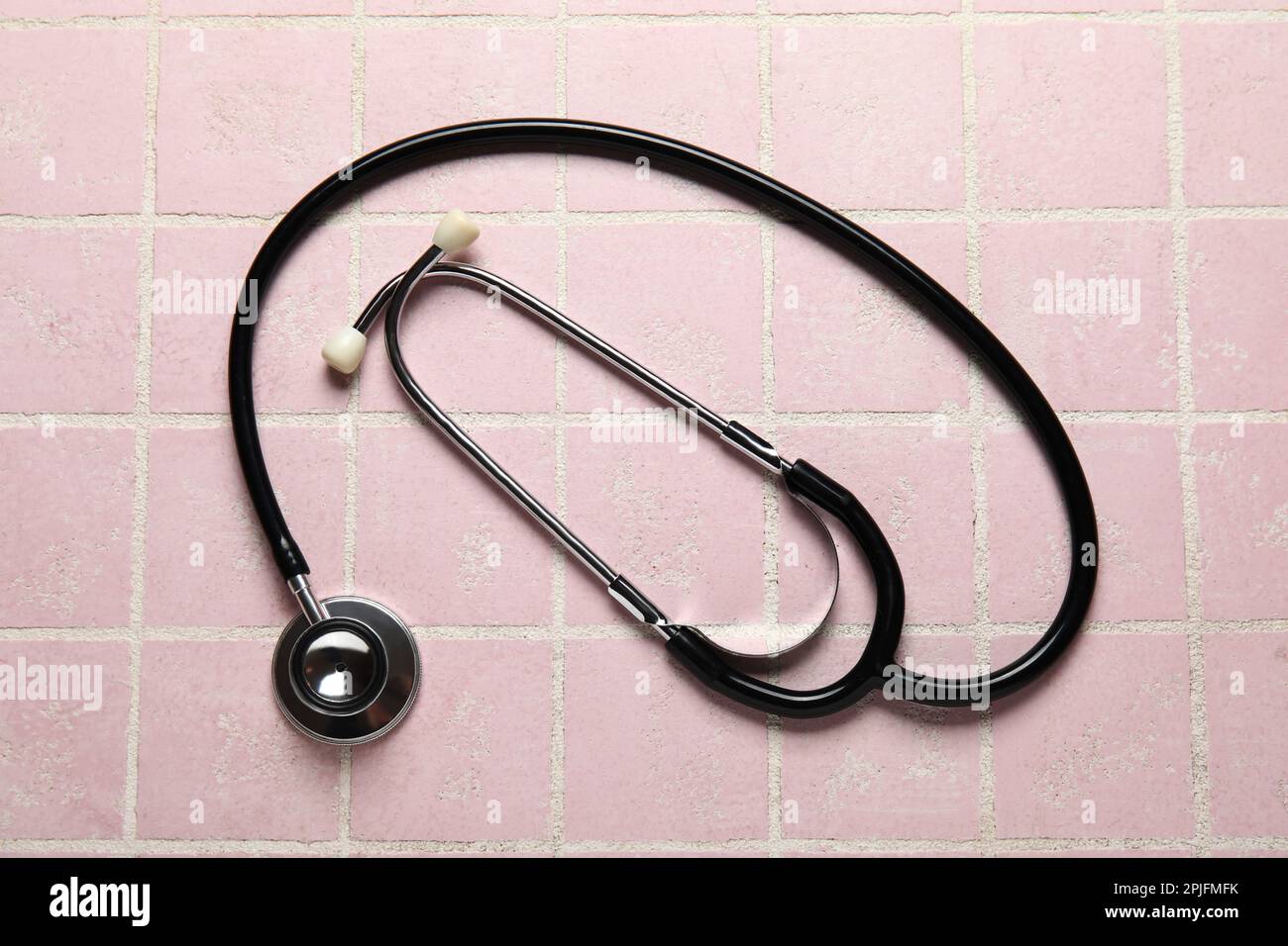 Modern stethoscope on pink background Stock Photo - Alamy