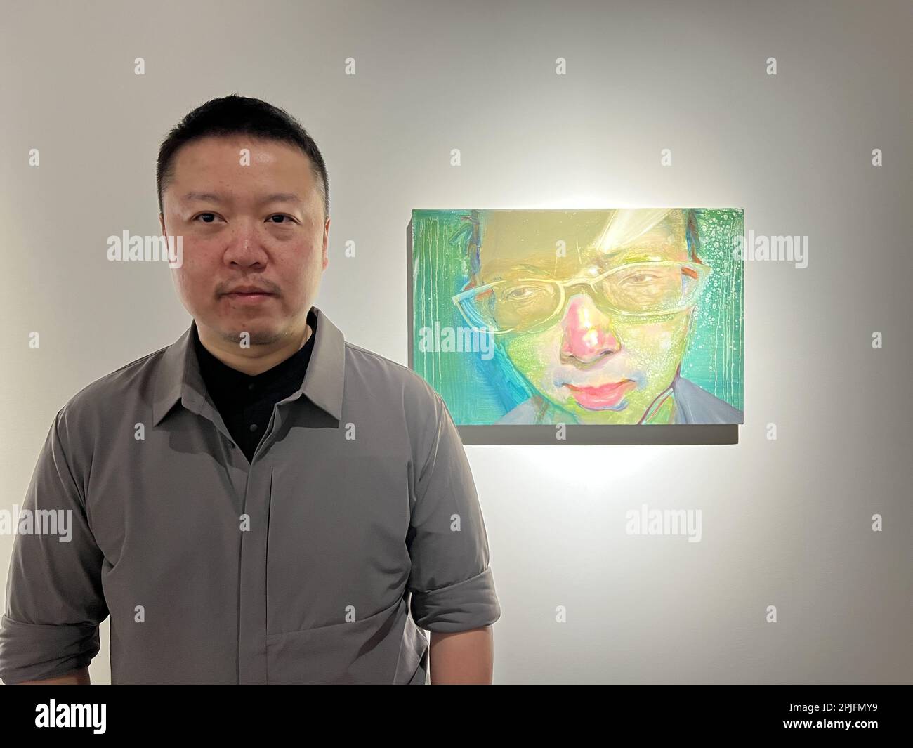 Chinese artist Wang Tuo photographed at Blindspot Gallery next to "The ...