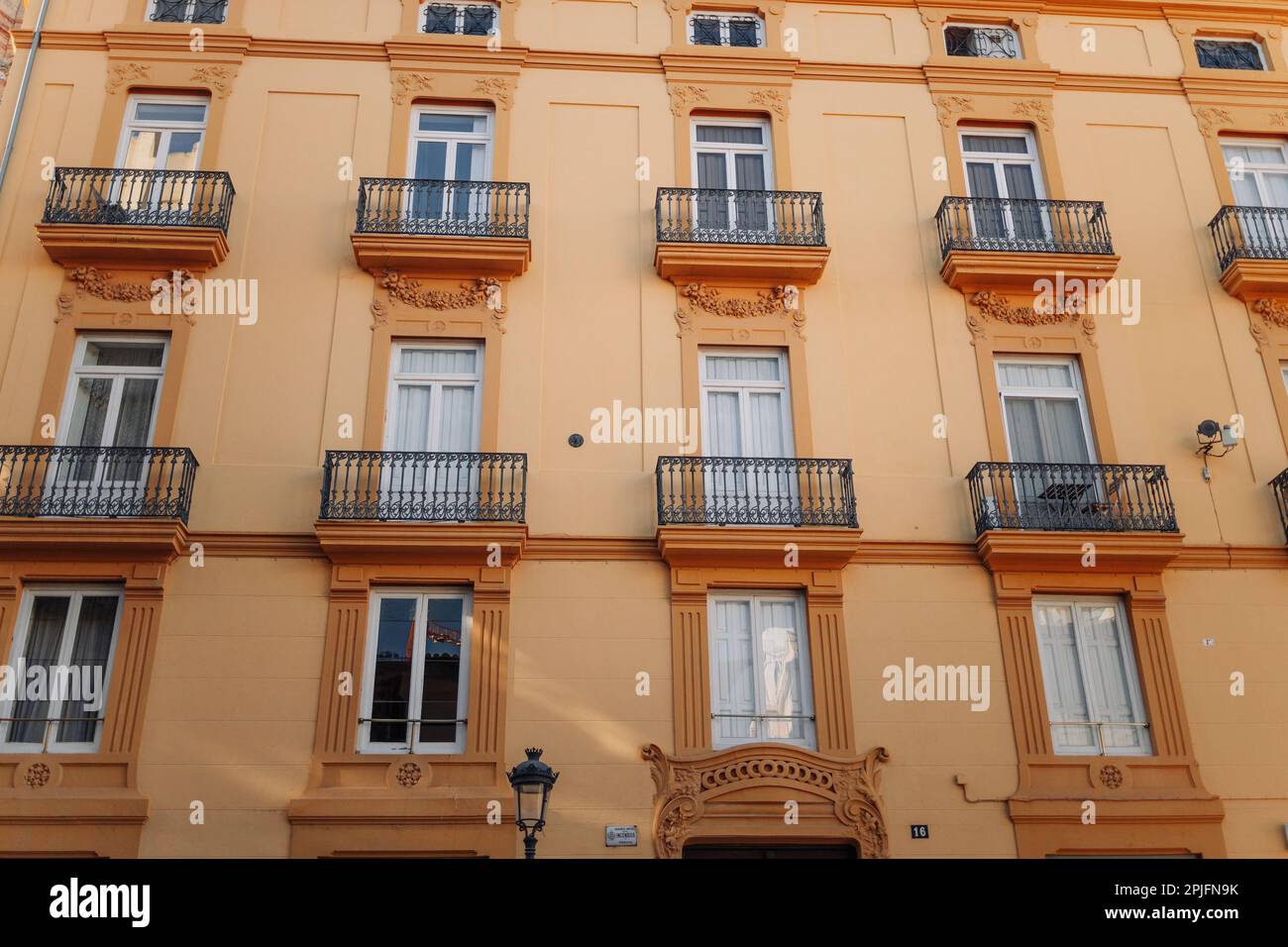 Windows with shutters and small balconies outside on the building ...