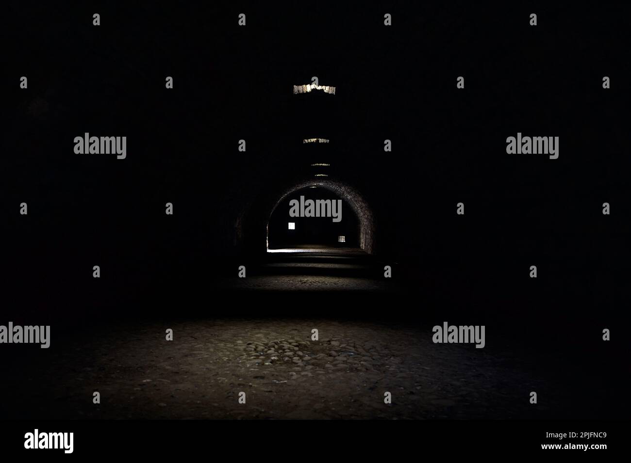 Dark and covered passage in the boundary wall of a castle Stock Photo ...