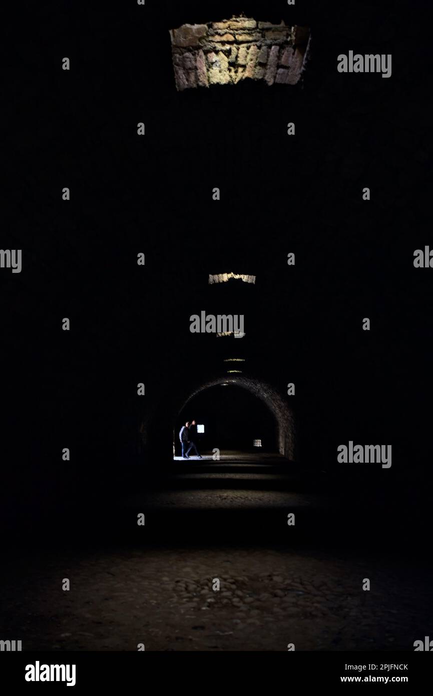 Dark and covered passage in the boundary wall of a castle Stock Photo ...