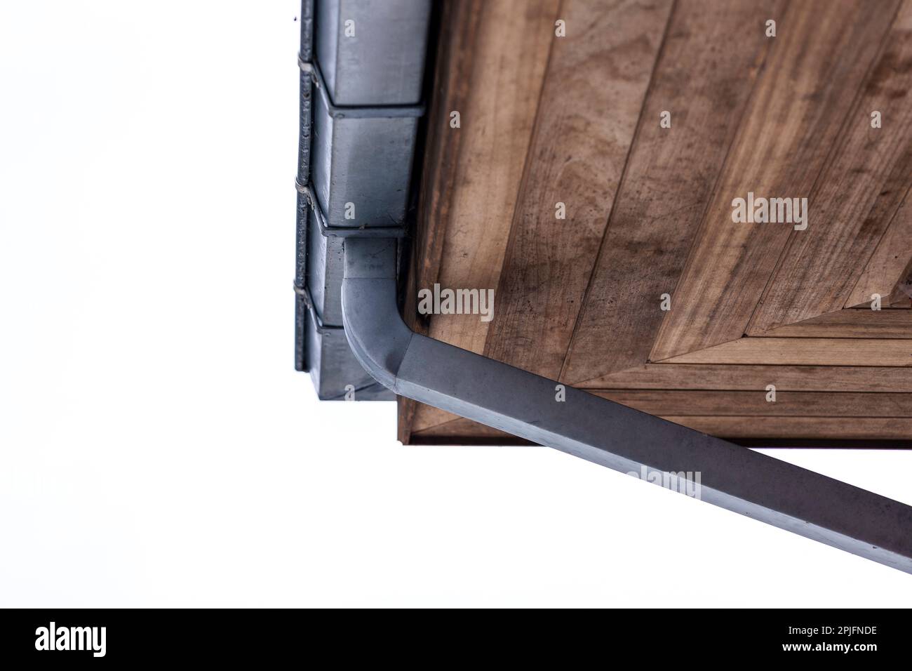 A close up portrait of a drain pipe of a metal roof gutter. It is used ...