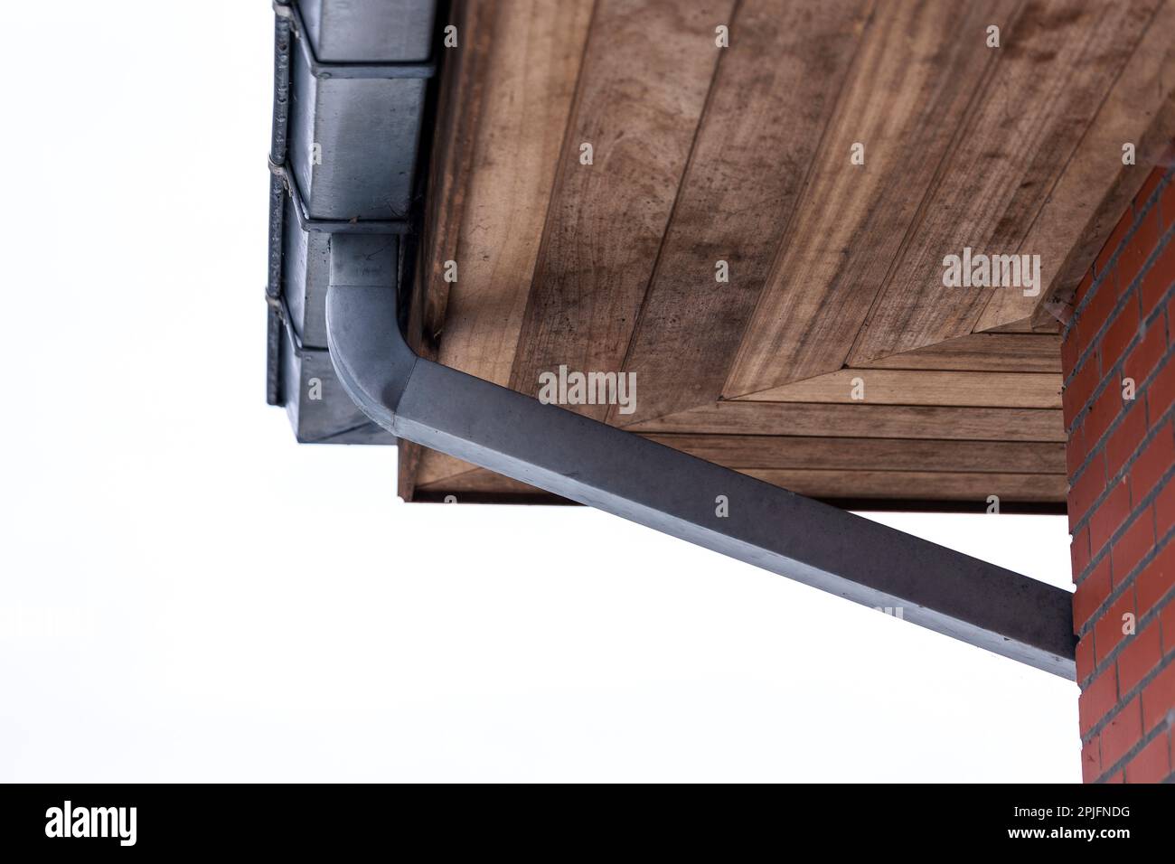 A portrait of a metal drain pipe of a roof gutter. It is used to direct ...