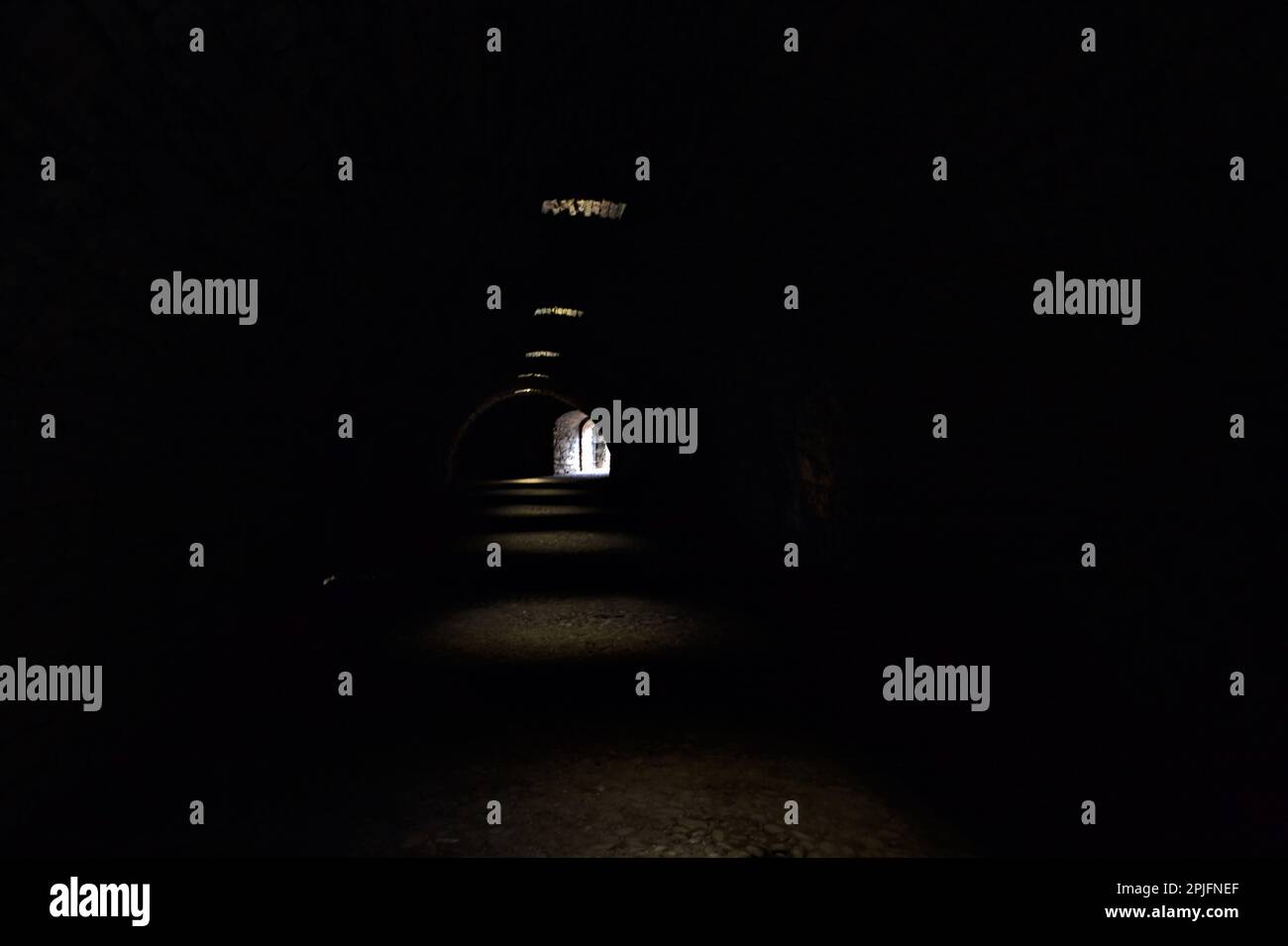 Dark and covered passage in the boundary wall of a castle Stock Photo ...