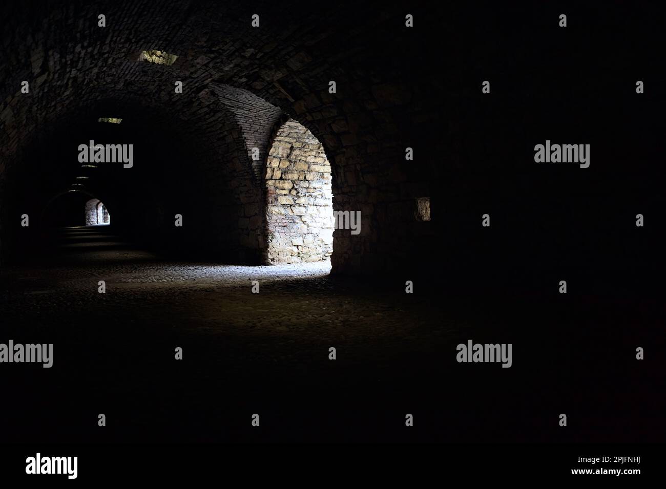 Dark and covered passage in the boundary wall of a castle Stock Photo ...