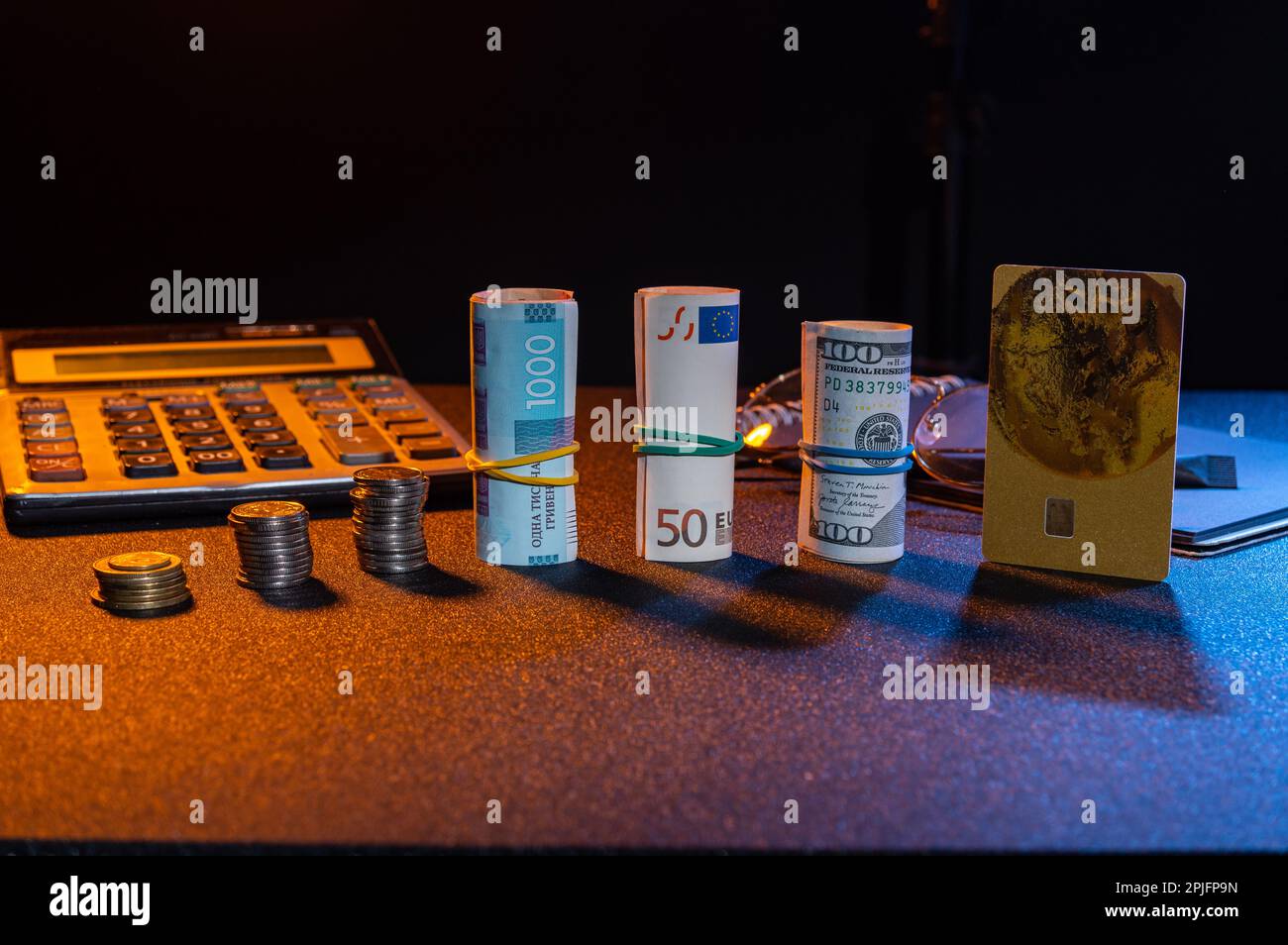 Change, currency and credit card stand in a row. Money lined up in a ...