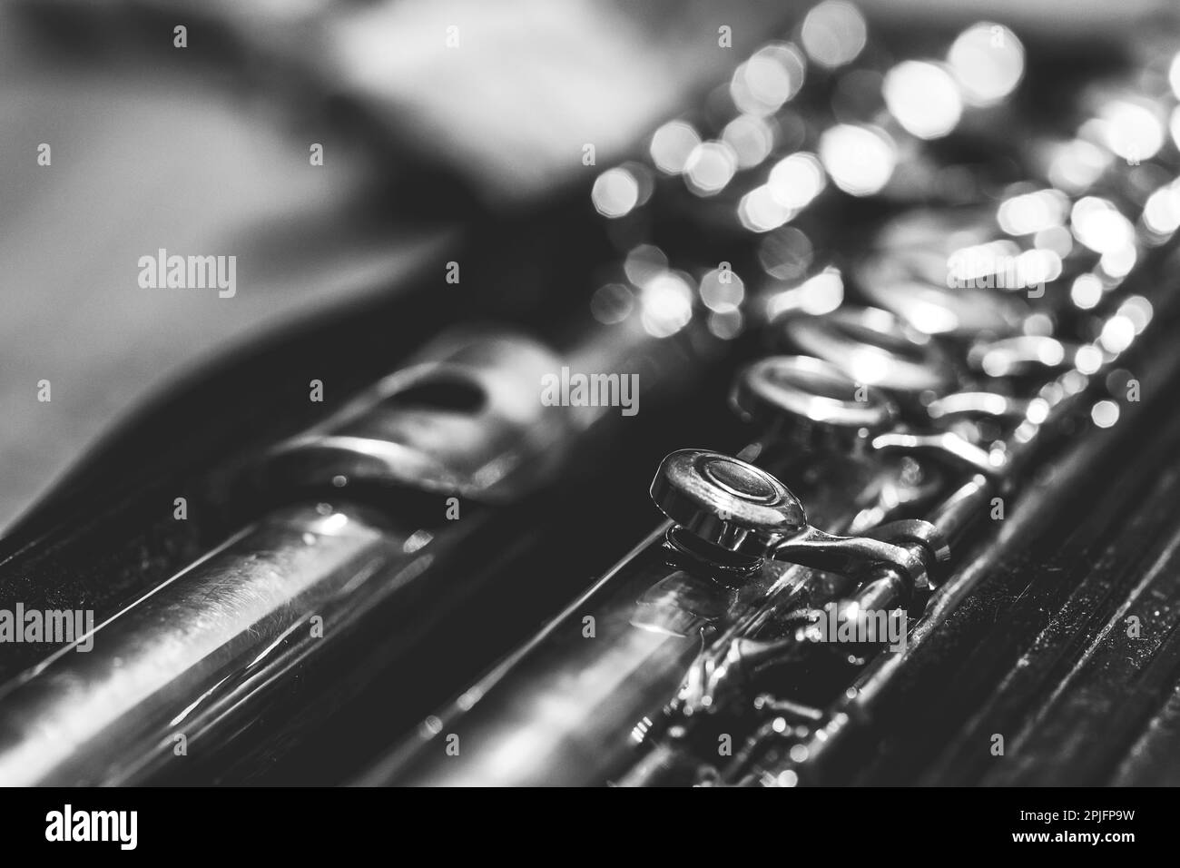 A black and white close up of a valve of a disassembled metal silver ...