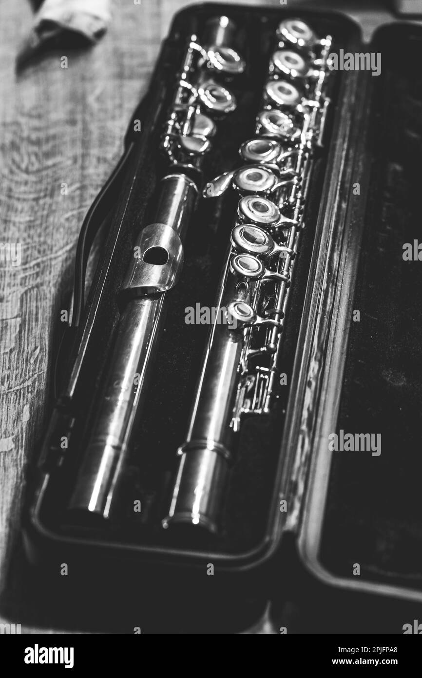 A portrait of a valve of a disassembled metal silver flute in a case ...
