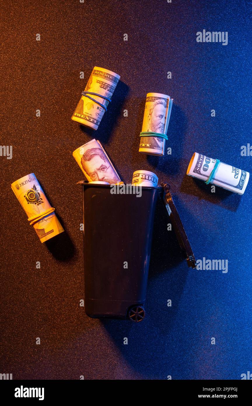 Bundles of money and trash can. Money in the trash. Movie light. View ...