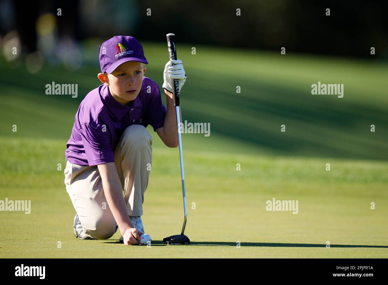 Emory Munoz, 8, of Lockport, Ill., prepares to putt at the Drive Chip ...