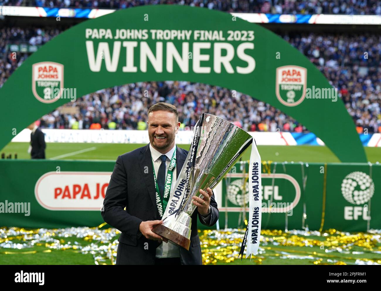 Bolton Wanderers manager Ian Evatt poses with the trophy after the Papa ...