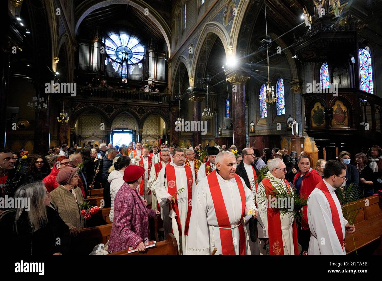 Catholic clerics enter the St. Joseph cathedral at the end of a Palm ...