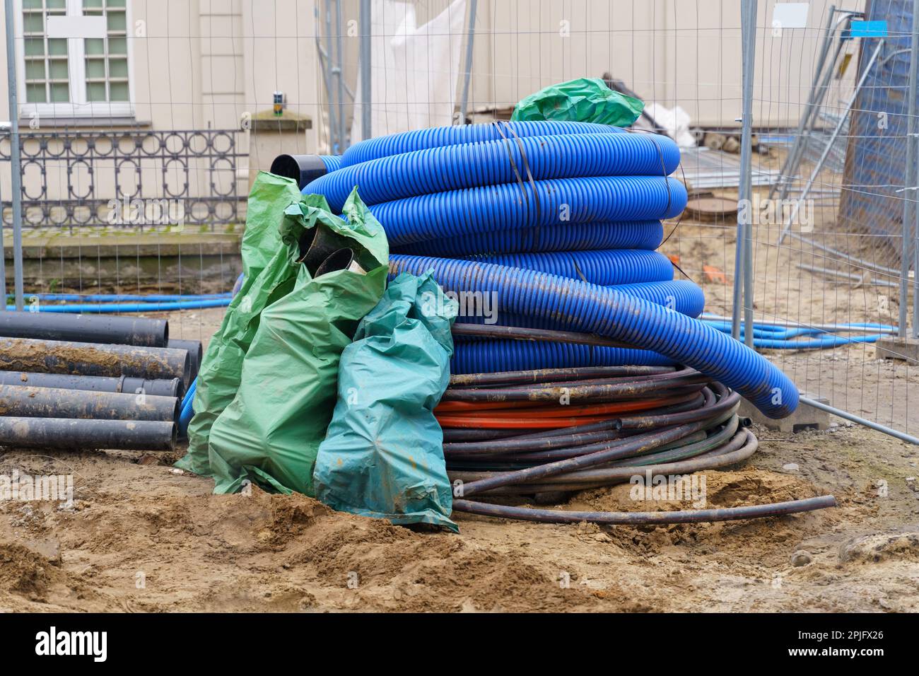 Blue corrugated and black pipelines of various diameters lie on a ...