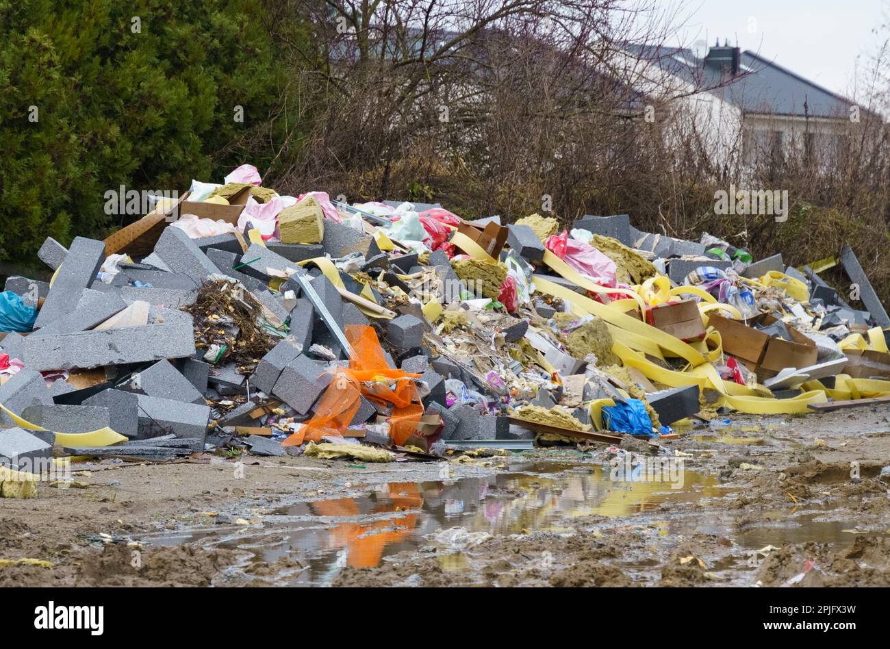 A pile of broken concrete blocks, fiberglass, plastic and other ...