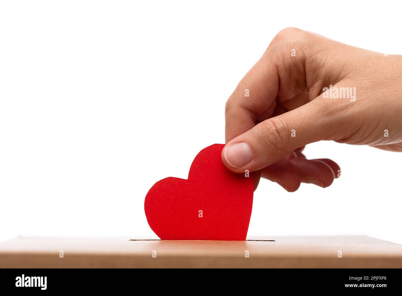 hand putting red heart into charity donation box Stock Photo - Alamy