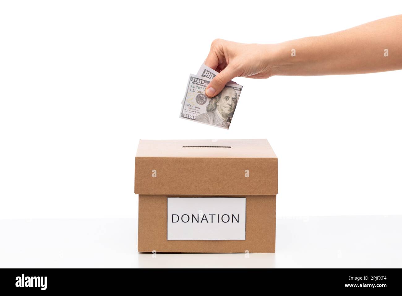 hand putting dollar cash money into donation box Stock Photo - Alamy
