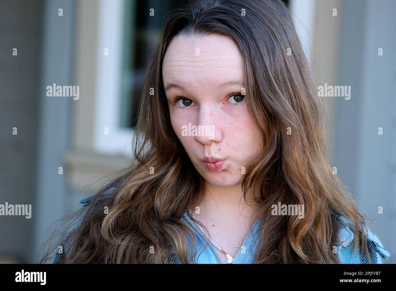 close-up face of teenage girl showing awkward uncertainty oops it ...