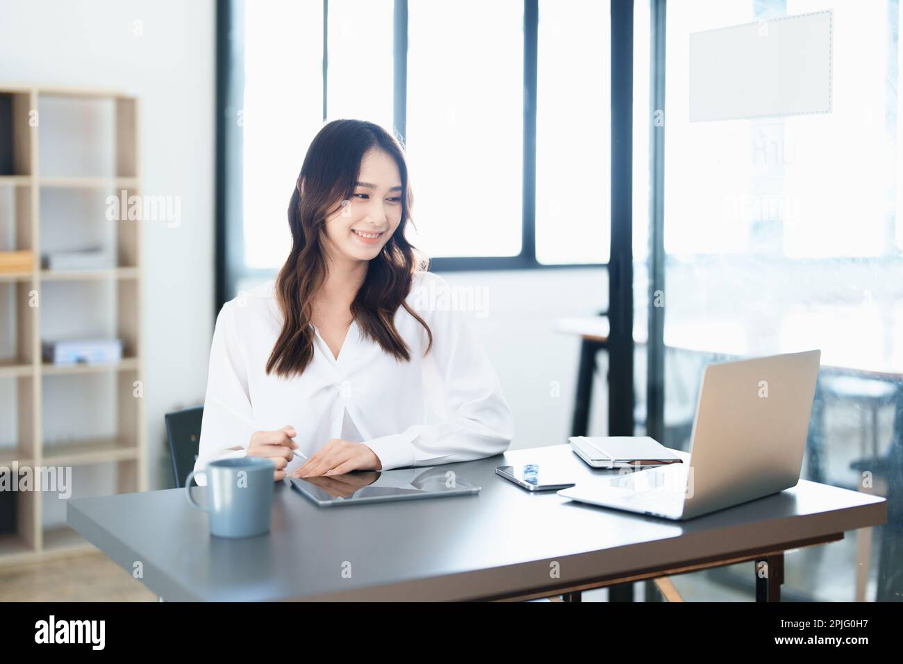 business owner or Asian female marketers are using tablet computer in ...