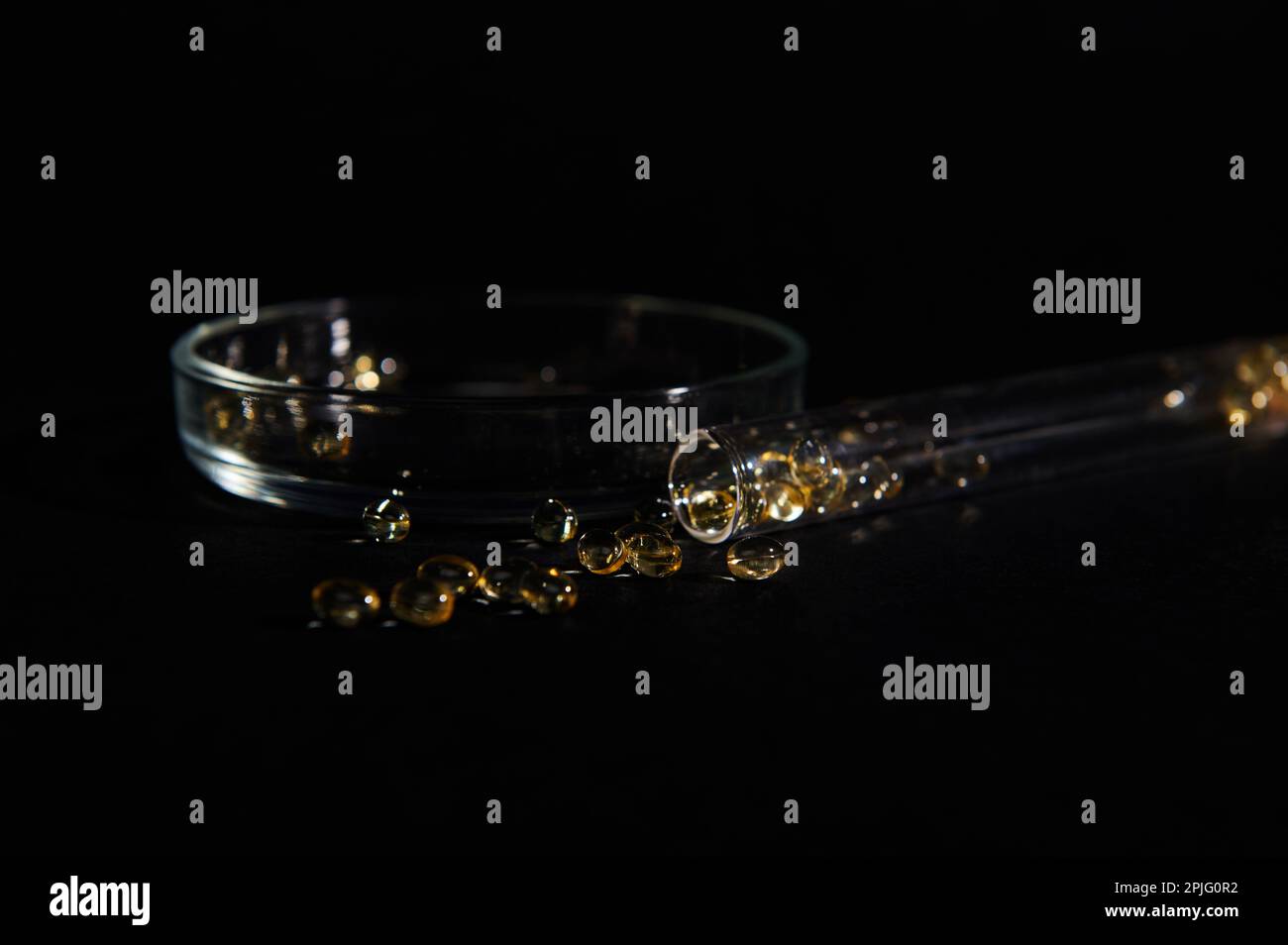 Still life. Golden color soft translucent gelatin capsules scattering ...