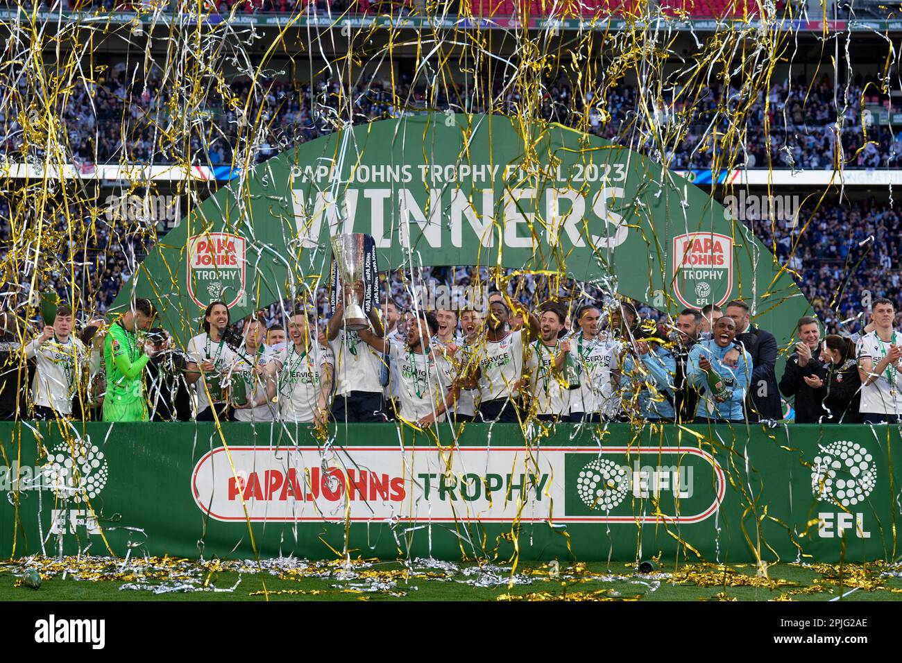 Bolton players celebrate their victory by lifting the trophy following ...