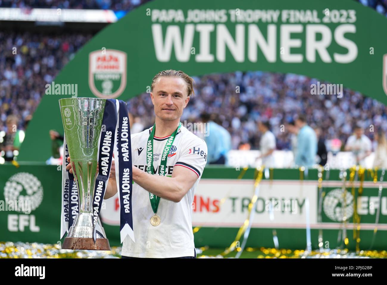 Bolton Wanderers’ Kyle Dempsey lifts the trophy following the Papa ...