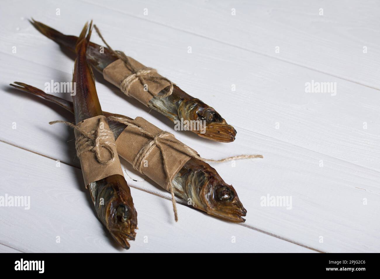 Putassu Cold smoked. The fish is wrapped with a strip of paper. Tied ...