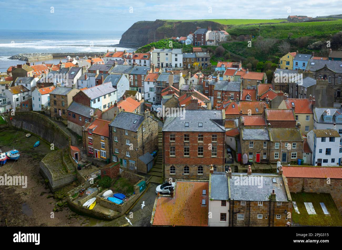 View looking seawards over the harbour of the North Yorkshire Village ...