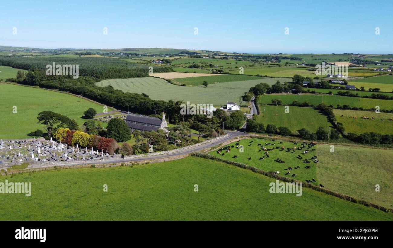 Old church and cemetery among green farm fields, top view. Picturesque ...