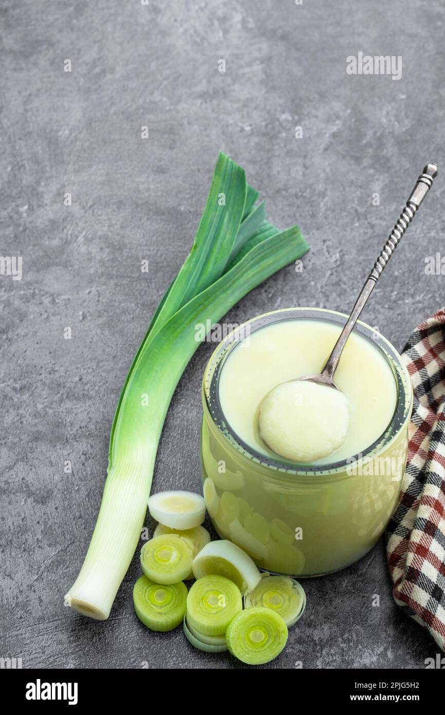 Vegetable leek puree in a glass jar on gray background Stock Photo - Alamy