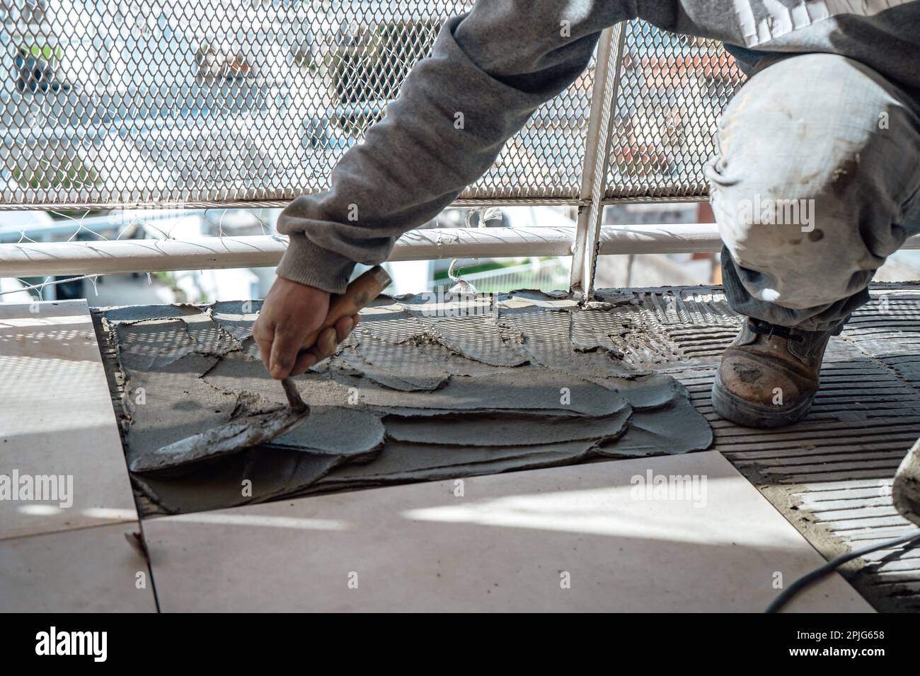 Mason placing cement on a slab with a mason's trowel. I work in a ...