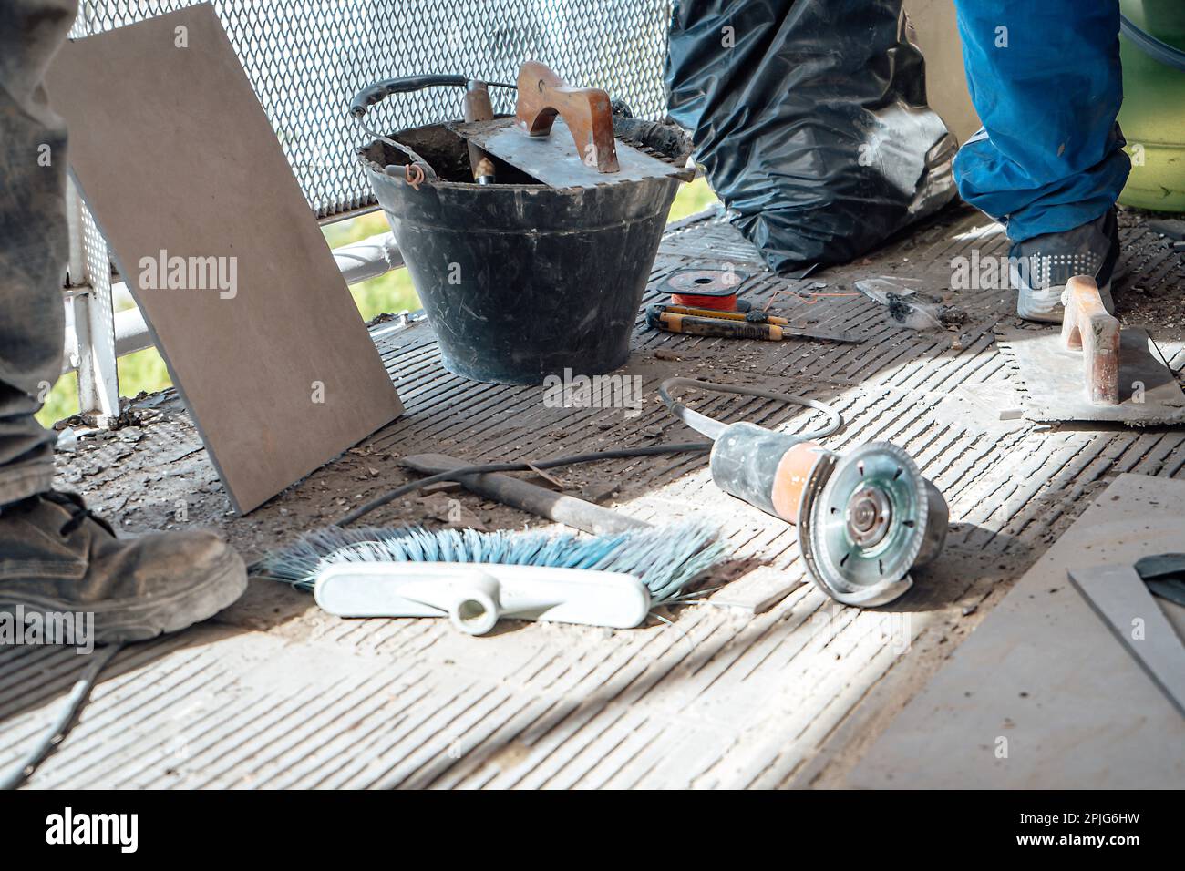 Mason's bucket with cement, a trowel and a grinder in a work. I work in ...