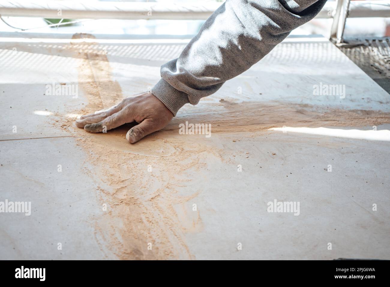 Mason passing the paste in the joint between tiles. I work in a ...