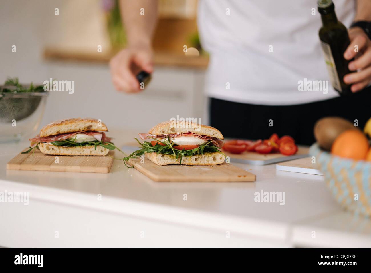 Man pouring cold pressed linseed oil on classic Italian bruschetta ...