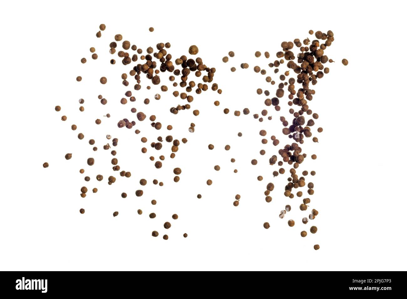 Freeze motion of flying mix of allspice isolated on white background ...