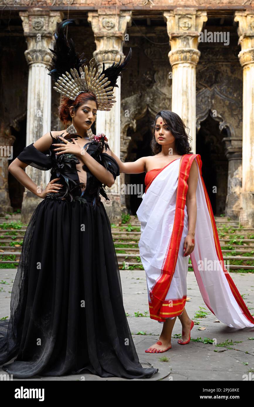 Portrait of two women in traditional ethnic red and white saree and in ...