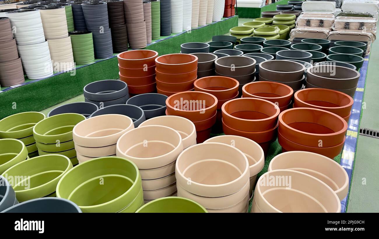 Close-up of empty flower pots in a store or greenhouse. Colorful pots ...