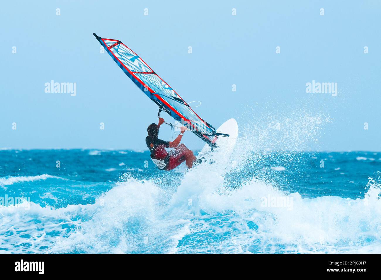aquatic sports: windsurfer jumping on the waves during the summer Stock ...