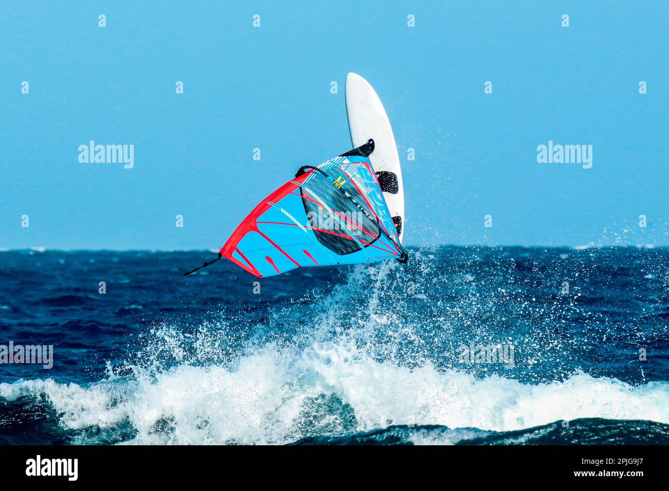 windsurfer jumps over the wave between the water splash Stock Photo - Alamy