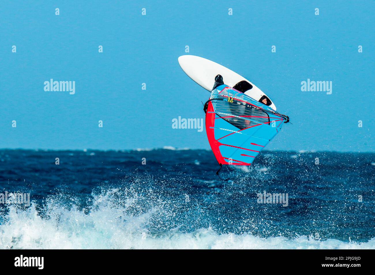 windsurfer making an acrobatic jump over the waves Stock Photo - Alamy