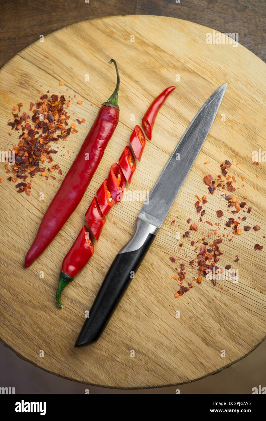 Red chili pepper cut into pieces on a black background. Hot spice, red ...