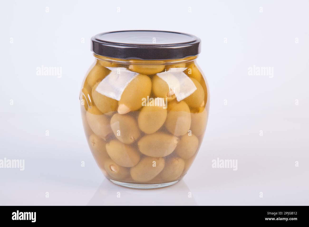 Jar of almond stuffed green olives on a white background. Jar of garlic ...