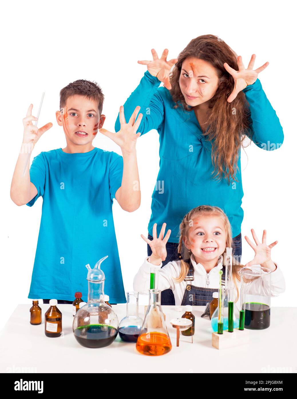 Three children working with chemical liquids at lesson Crazy scientist ...