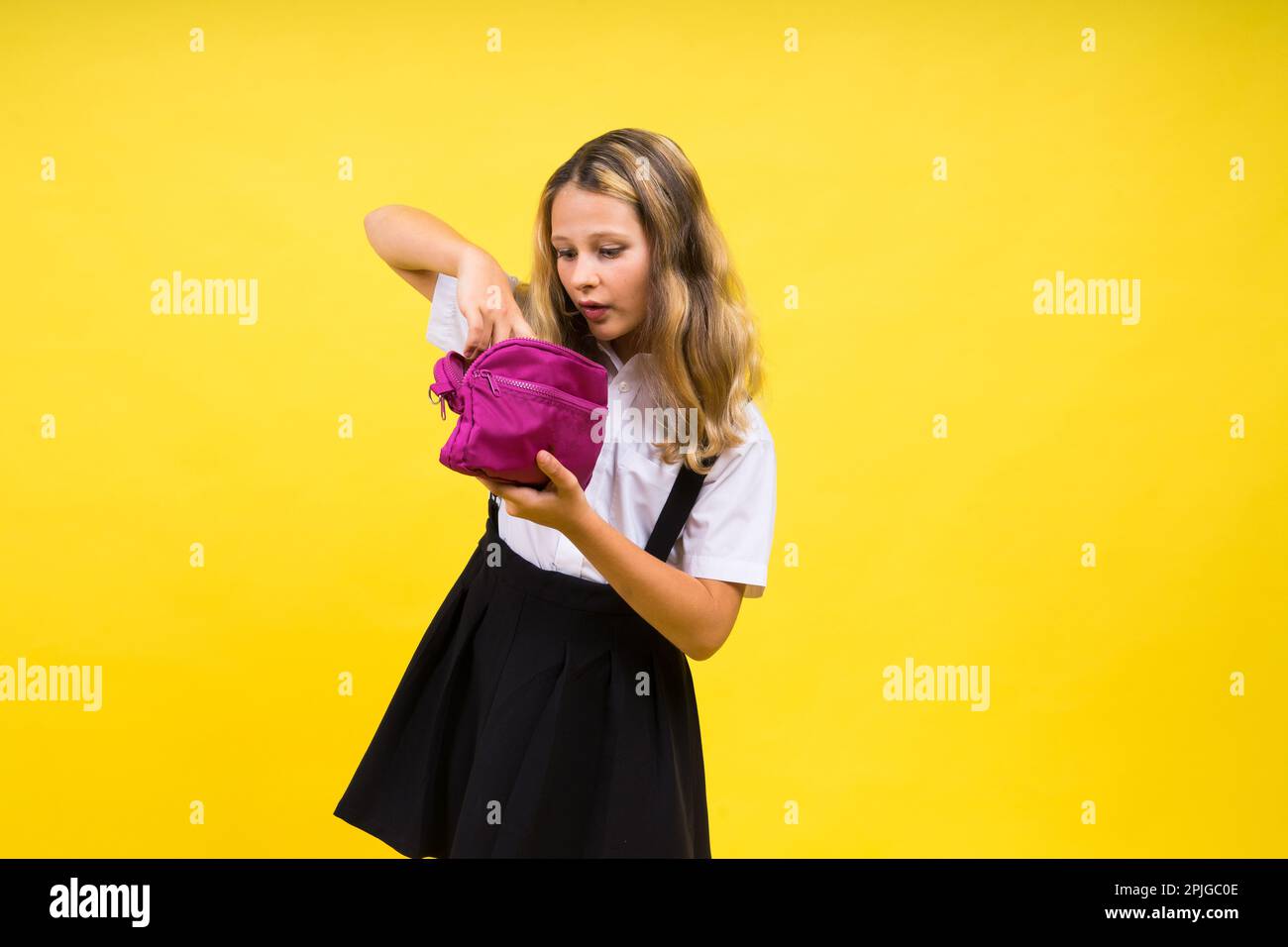 Little teenager girl with pencil case on a yellow background Stock ...