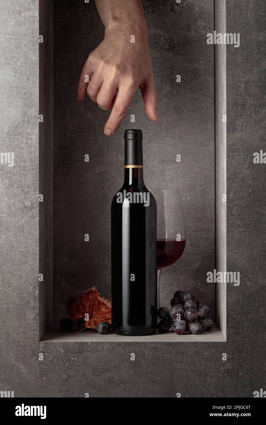 Bottle of red wine with grapes. Hand reach for a bottle of wine Stock ...