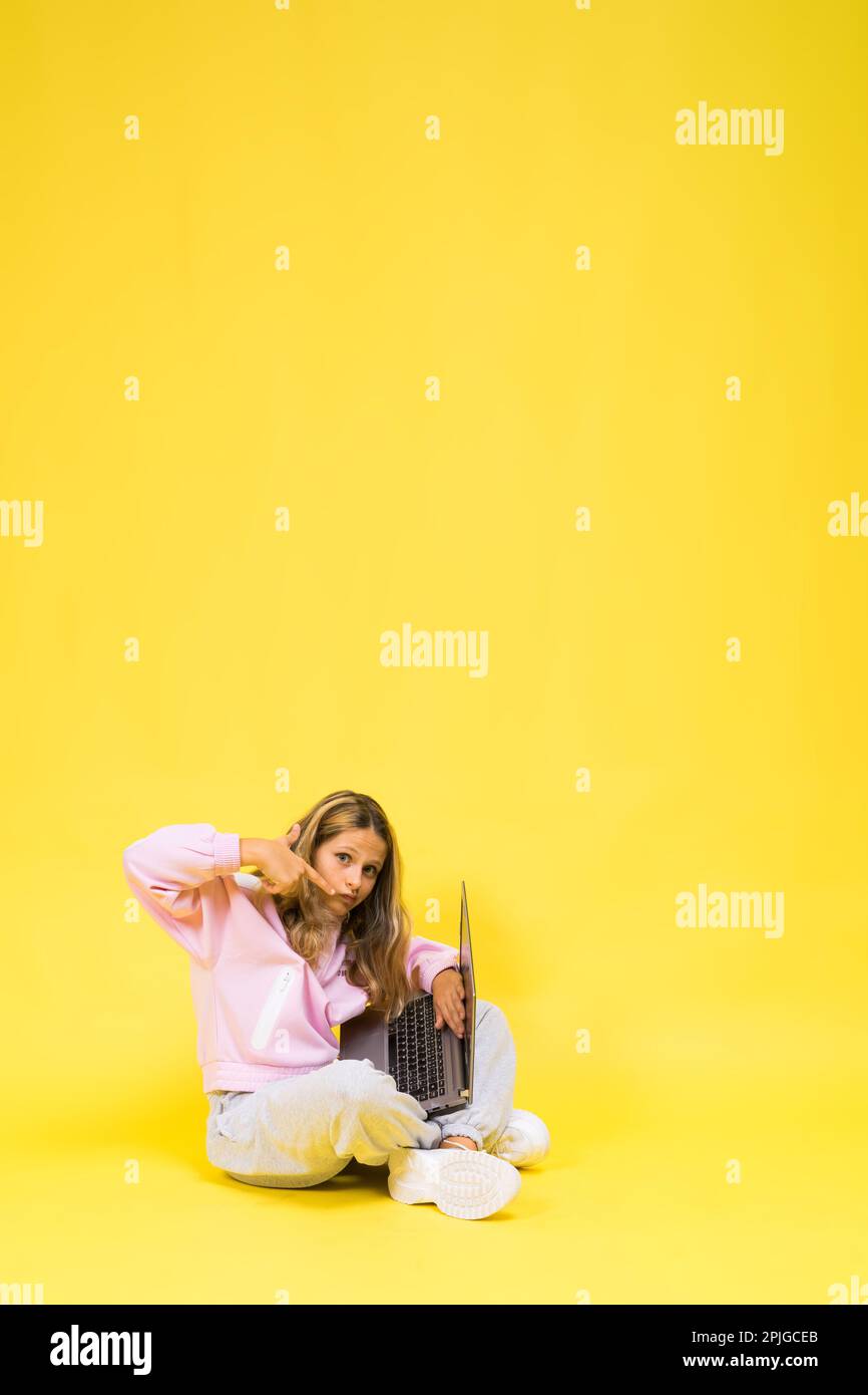 Positive kid sit with a laptop read homework wear casual style cloth ...